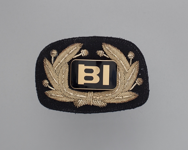 Objects | flight officer cap badge: Braniff International | SFO Museum